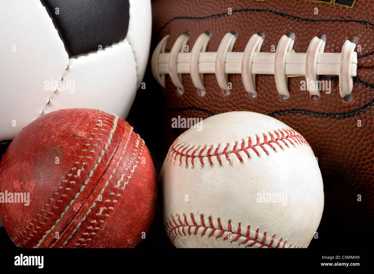 Assorted sports balls including a soccer ball, American football ...