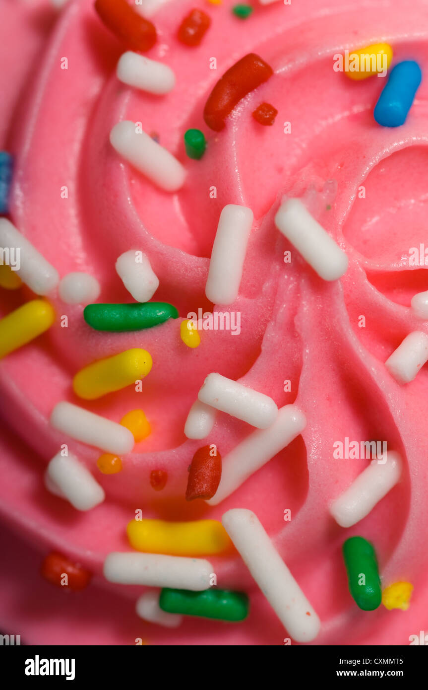 background of pink icing on cupcake with candy sprinkles Stock Photo ...