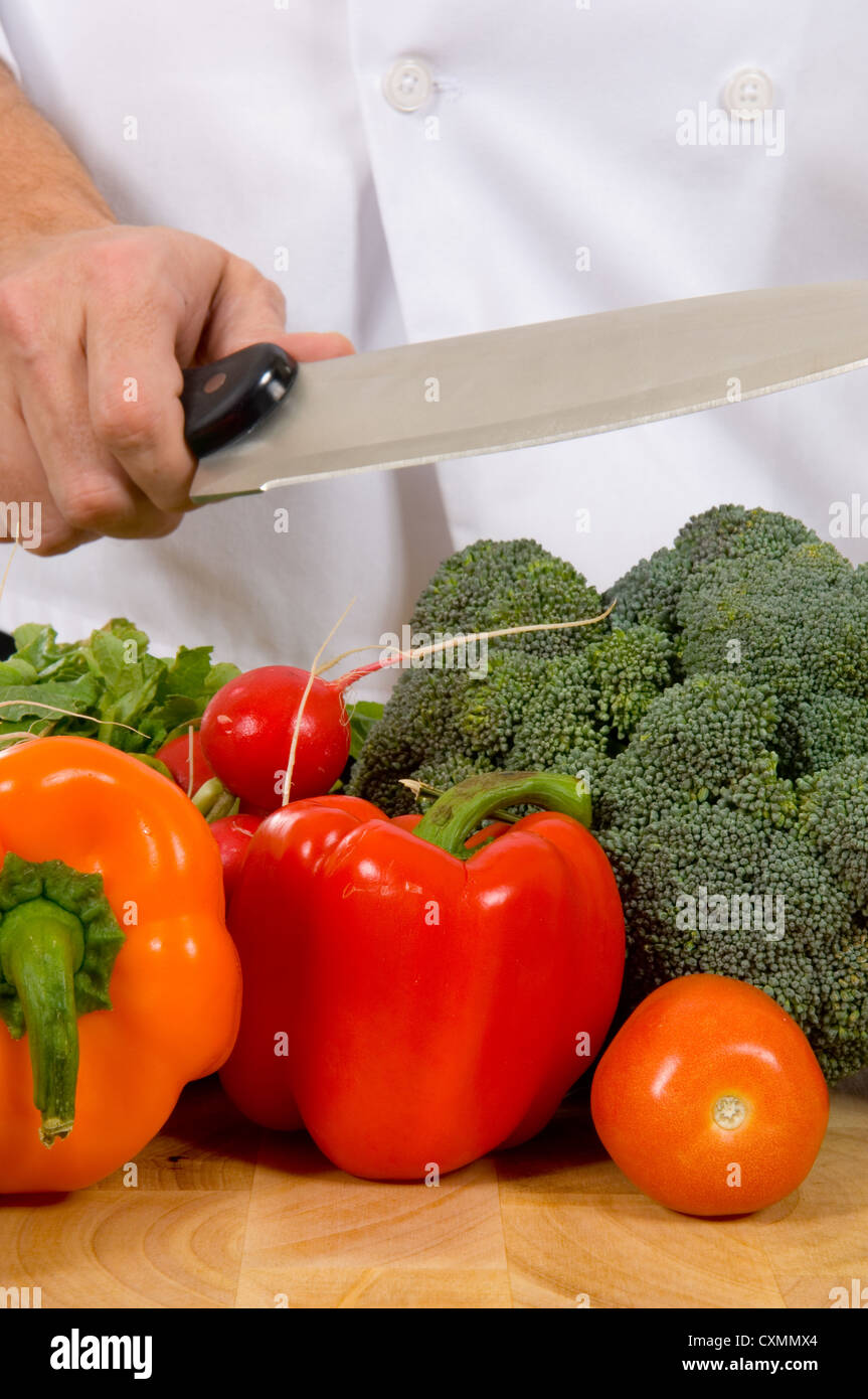 Chef with knife and a cutting board of fresh vegetables Stock Photo - Alamy