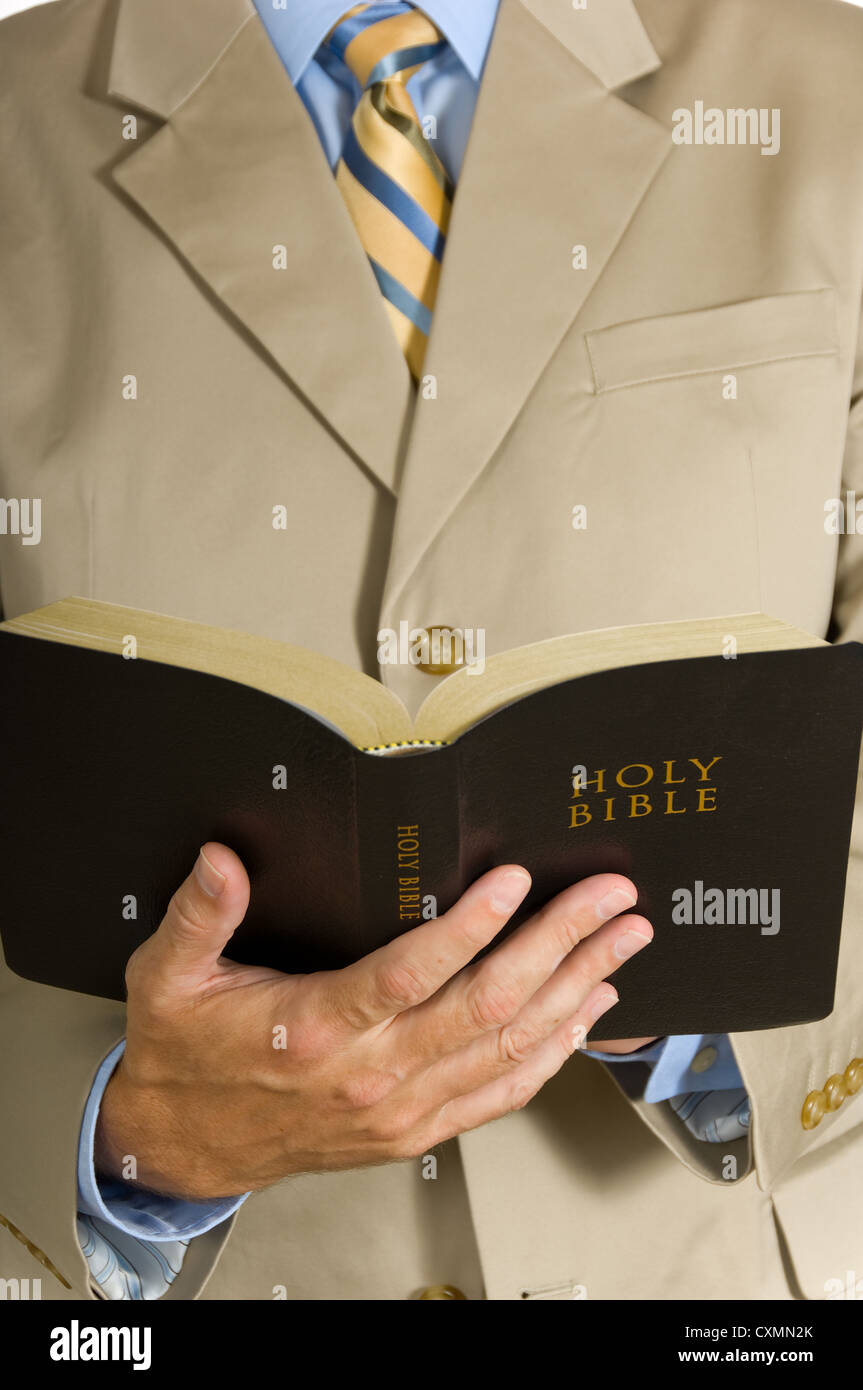 Man in business suit or preacher holding the BIble Stock Photo - Alamy