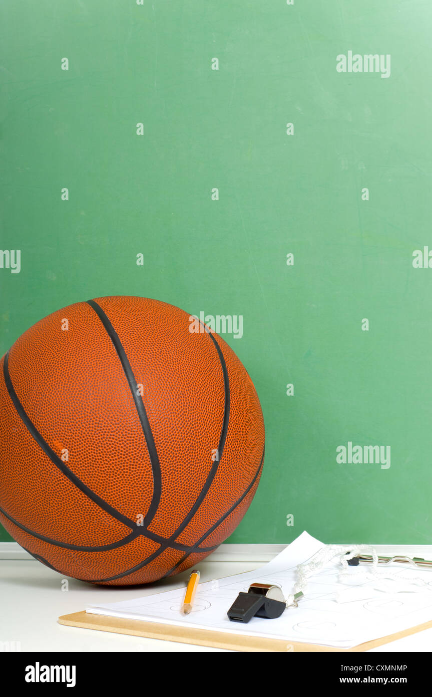 Items used by a basketball coach including a ball and a black board ...