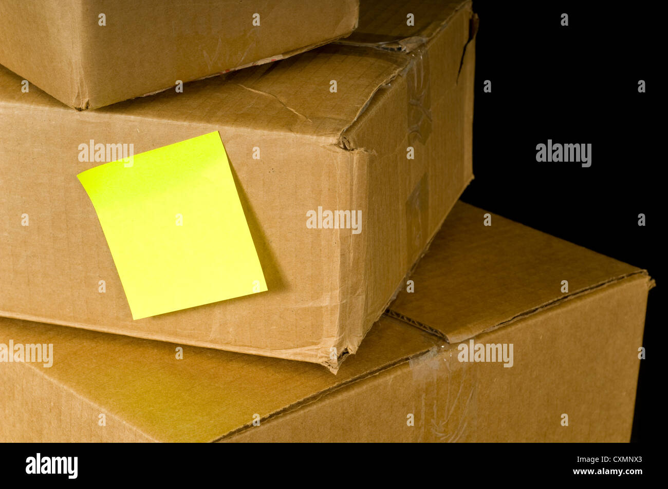 Brown corrugated boxes with a post-it or sticky note to add copy, on a ...
