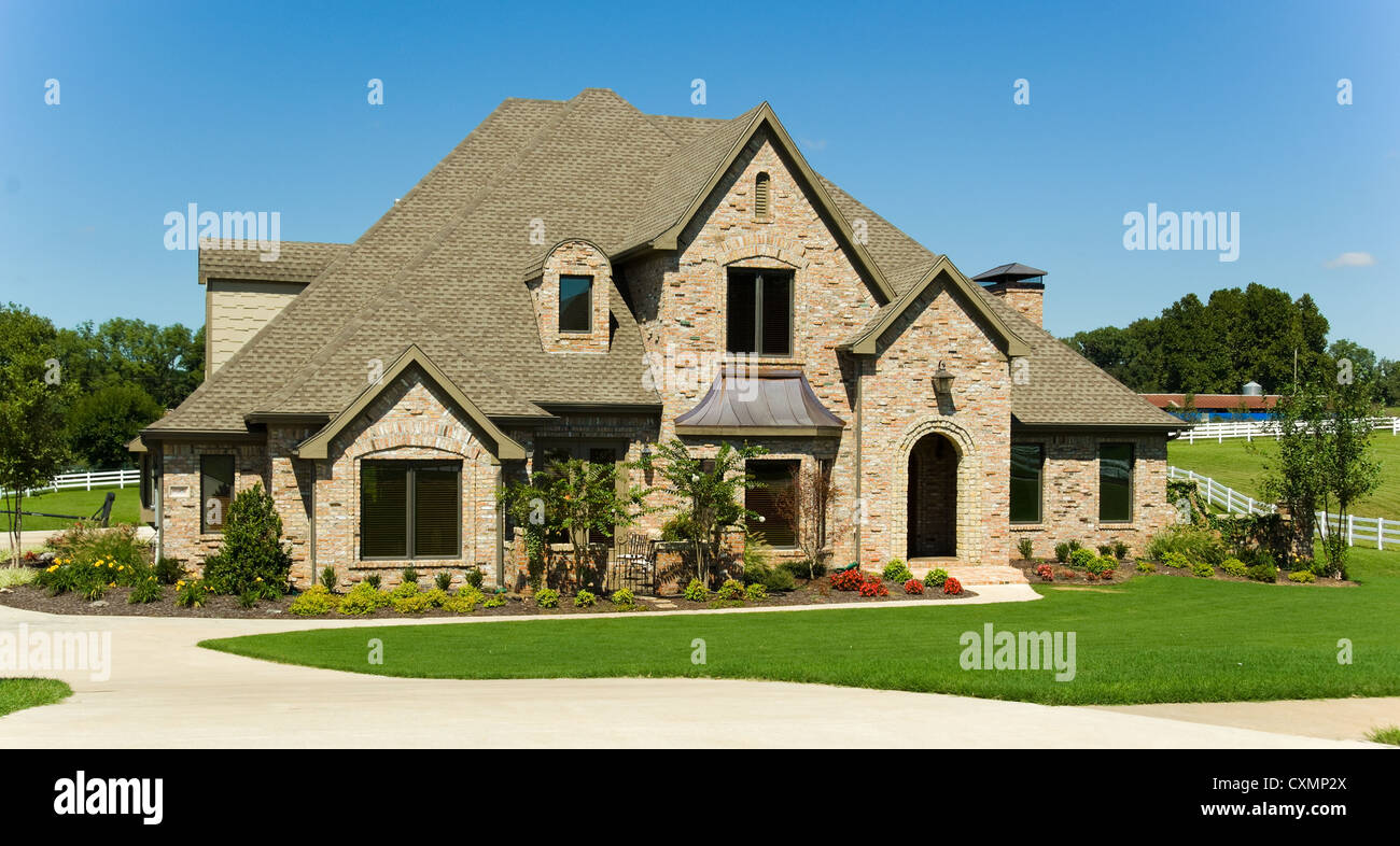 Beautiful two story home with landscaped yard against blue sky Stock ...