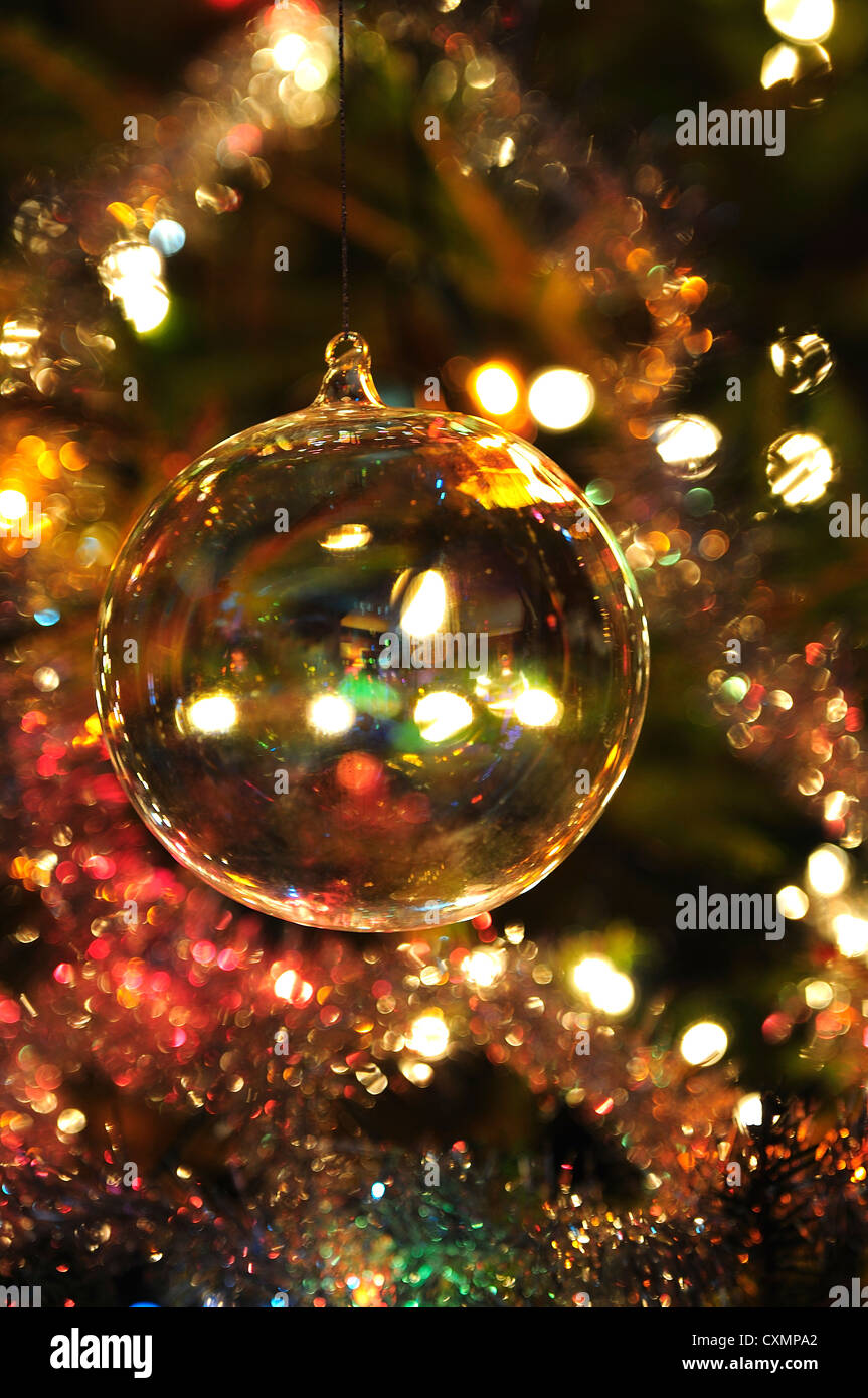 A bauble decoration on a Christmas tree with shining lights UK Stock ...