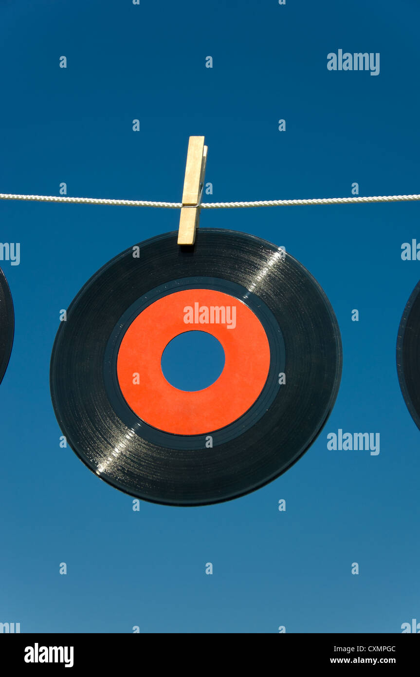 Old, vintage vinyl record hanging on a clothesline with a clothespin ...