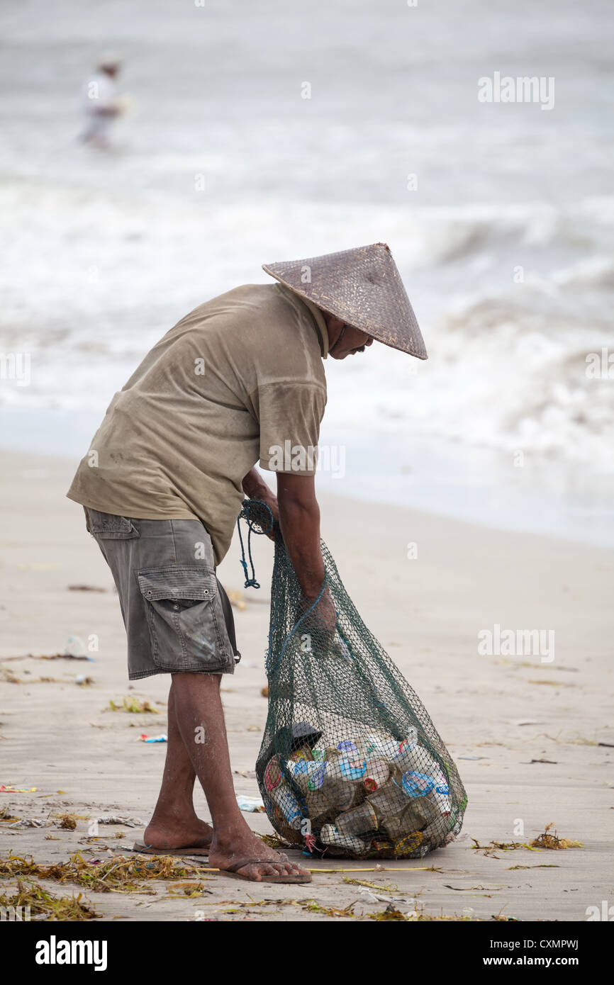 Rubbish Collector at Work on Kuta Beach on Bali Stock Photo - Alamy