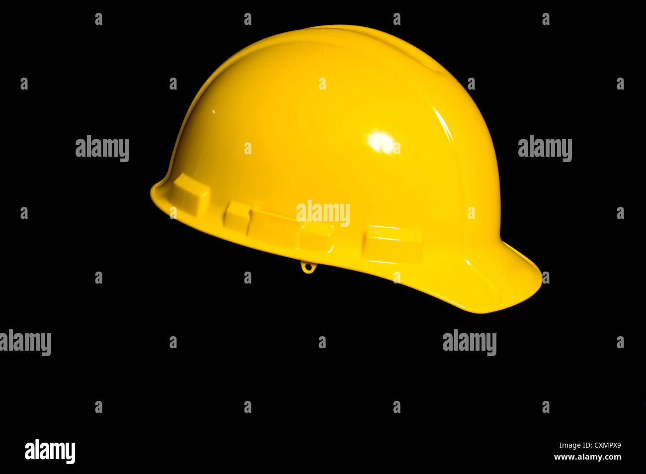 Yellow protective hard hat on black background Stock Photo - Alamy