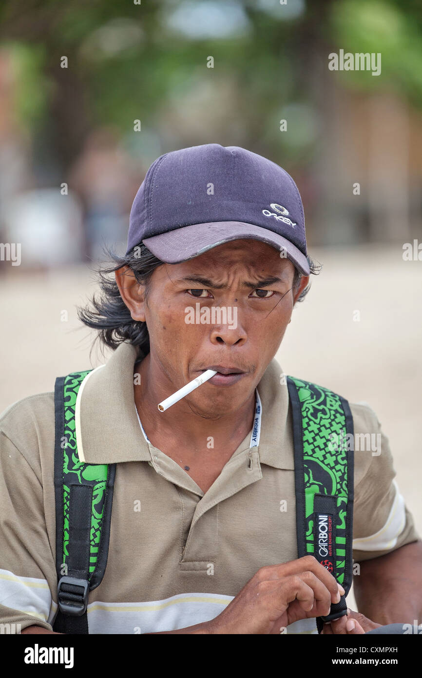 Balinese Smoker on Kuta Beach on Bali Stock Photo - Alamy