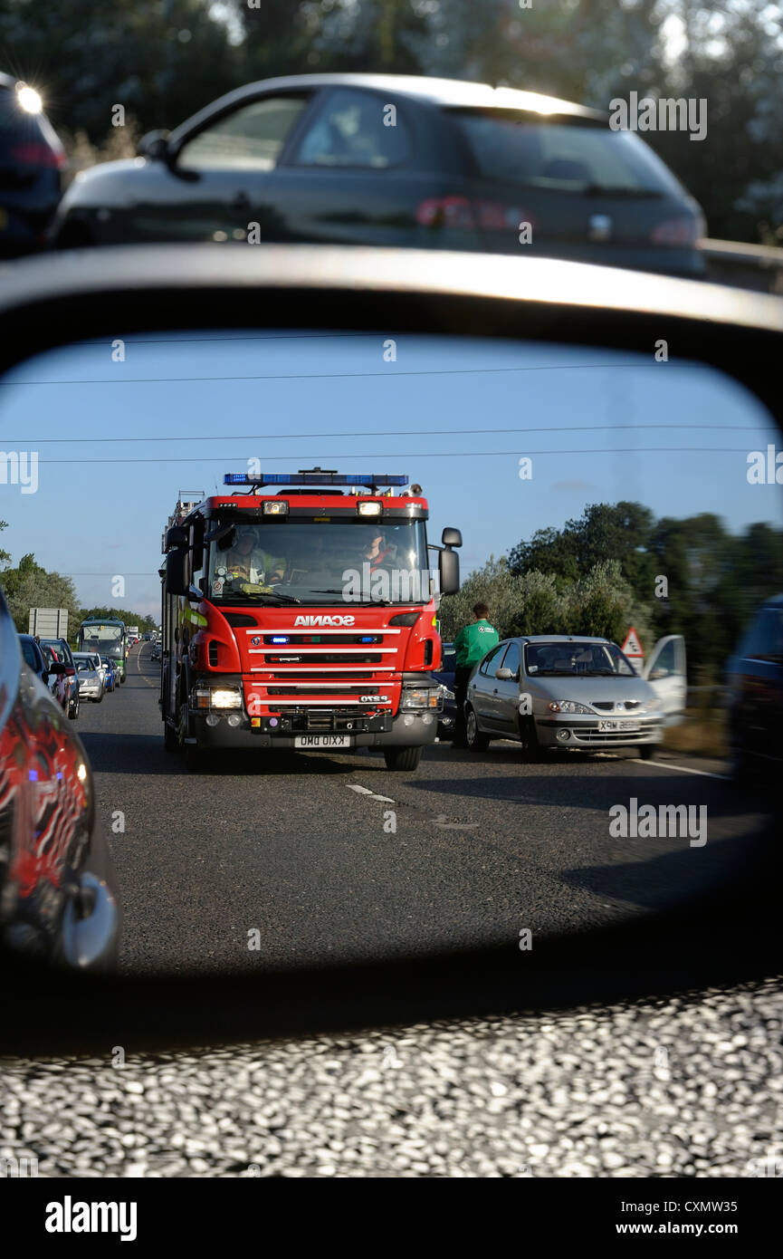 fire engine on its way to a road traffic accident seen through a car ...
