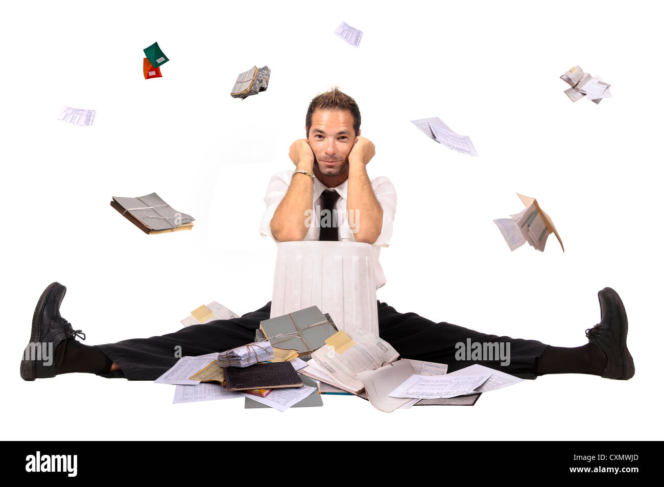 Businessman doing splits with office trash Stock Photo - Alamy