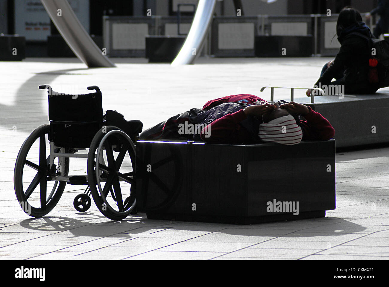 Disabled person relaxing on a bench Stock Photo - Alamy