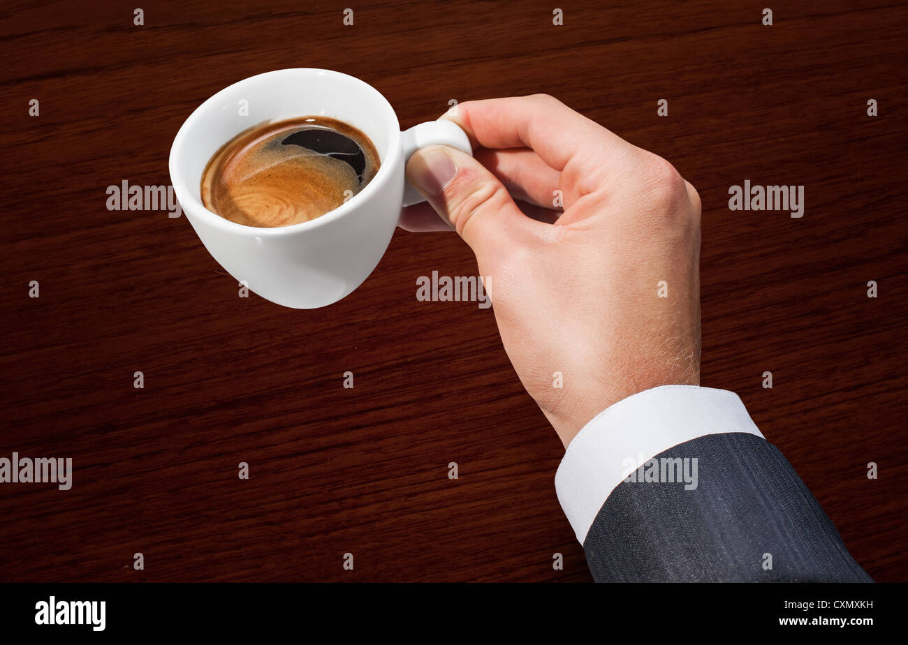 Businessman hand holding a cup of coffee Stock Photo - Alamy