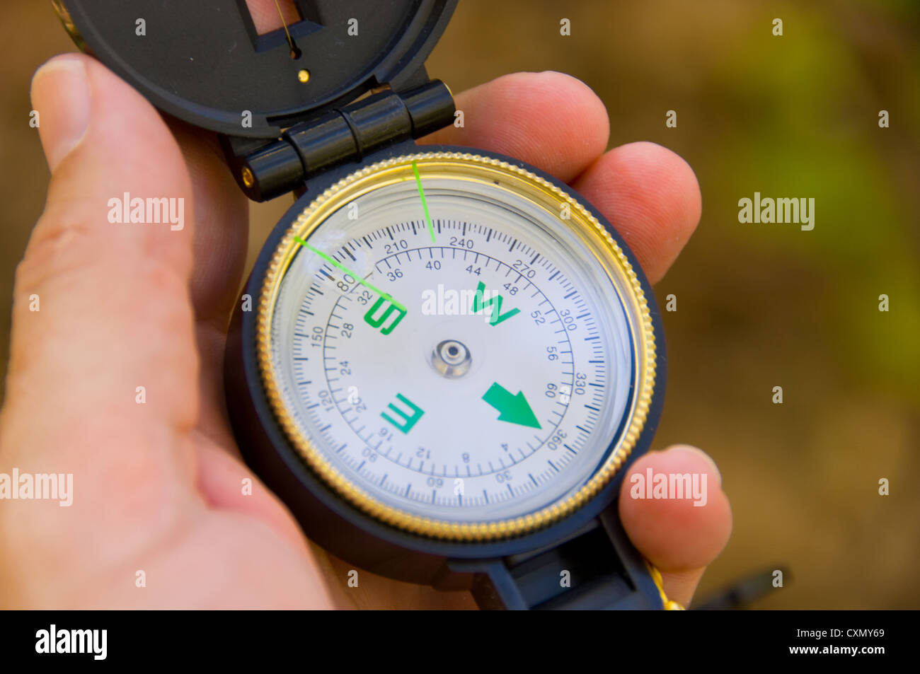man's hand holding a compass looking for directions Stock Photo - Alamy