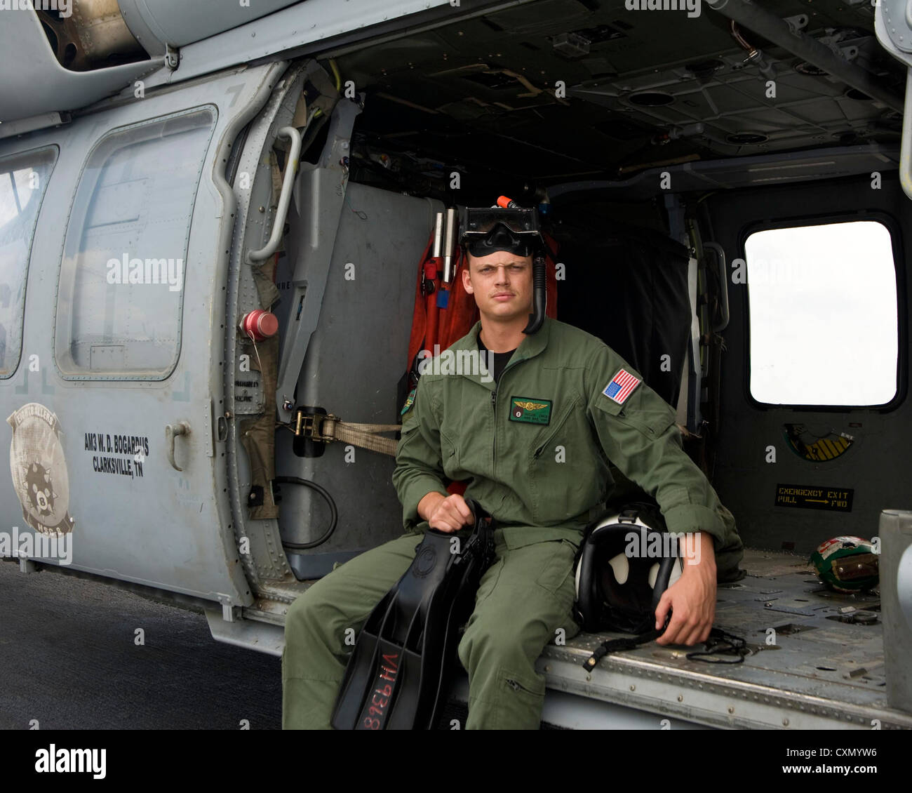Naval Aircrewman 3rd Class Tyler Child, aboard an MH-60S Knighthawk ...