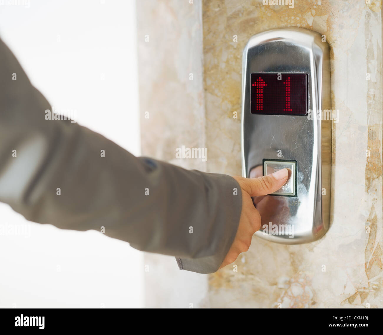 Woman pushing lift button elevator hi-res stock photography and images ...