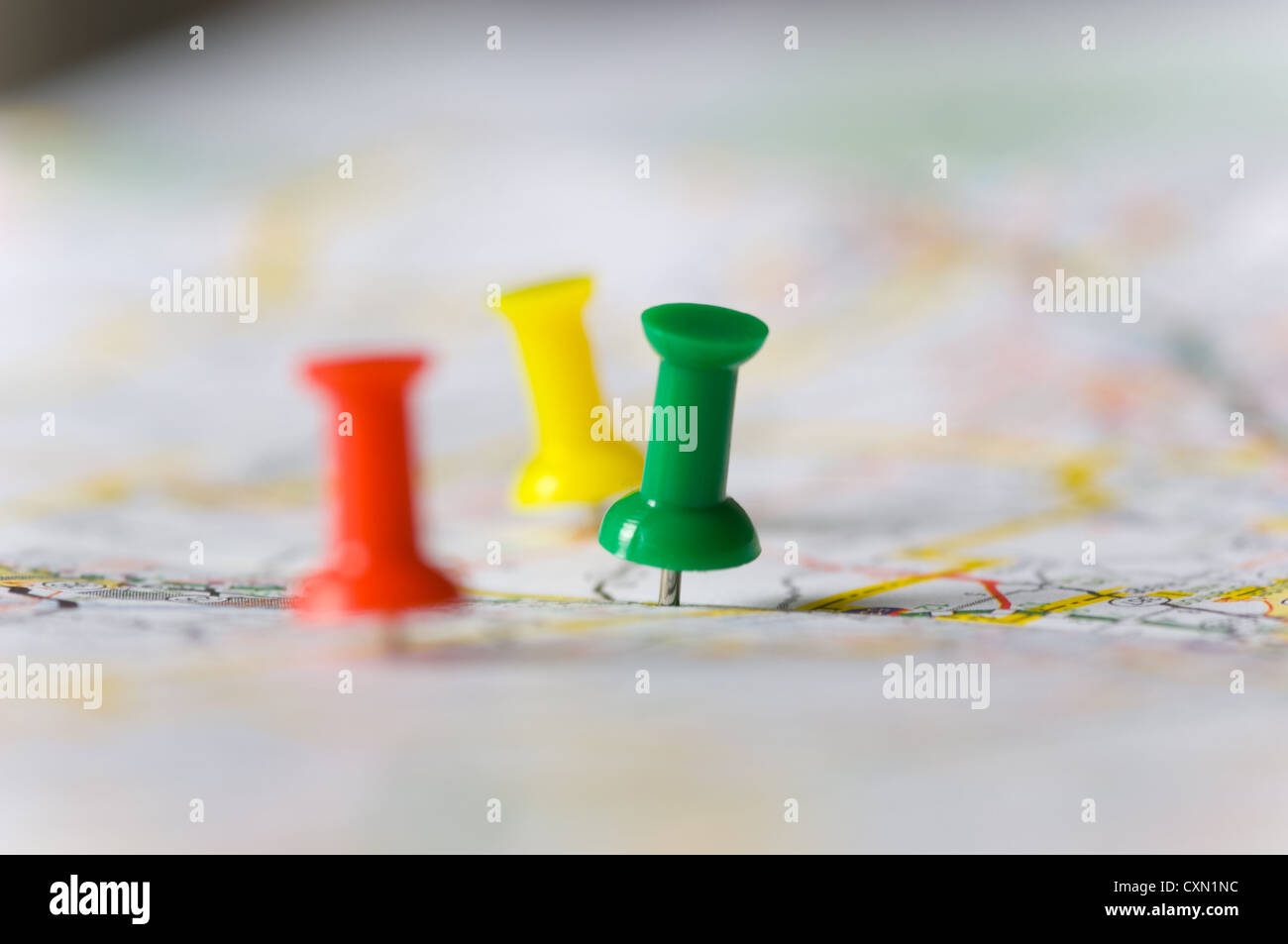 Red, yellow and green pushpins on a map Stock Photo - Alamy