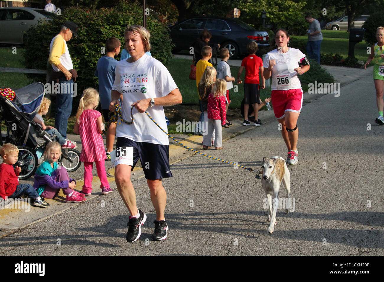 Woman running with a dog Stock Photo - Alamy