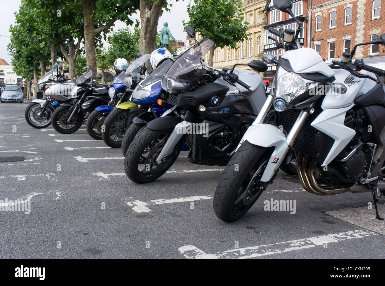Row of motorcycles parked under trees Stock Photo - Alamy