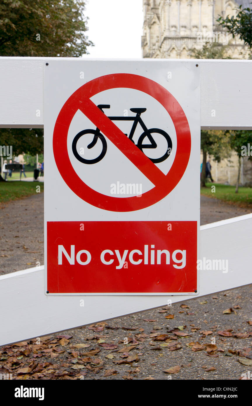 No cycling sign mounted on white gate at entrance to public pedestrian ...