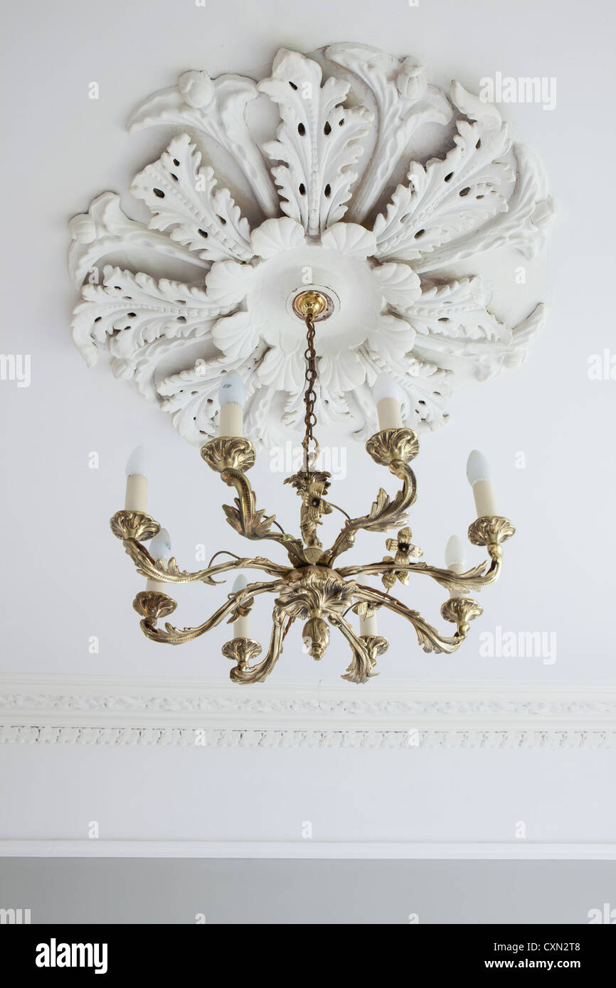 Ceiling rose with ornate chandelier Stock Photo - Alamy