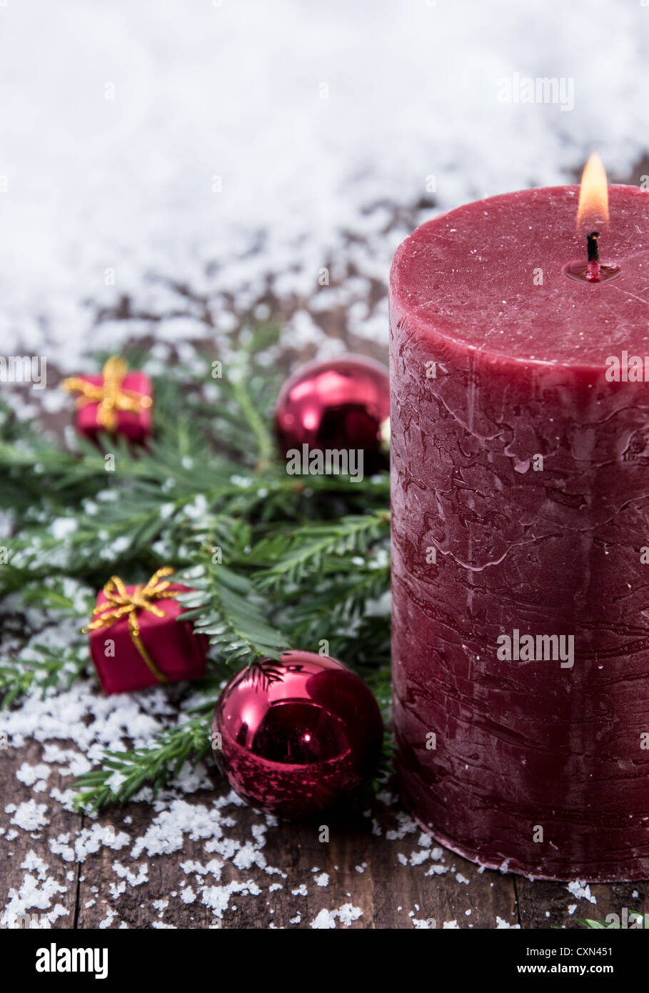 Rustical red Candles in the snow Stock Photo - Alamy