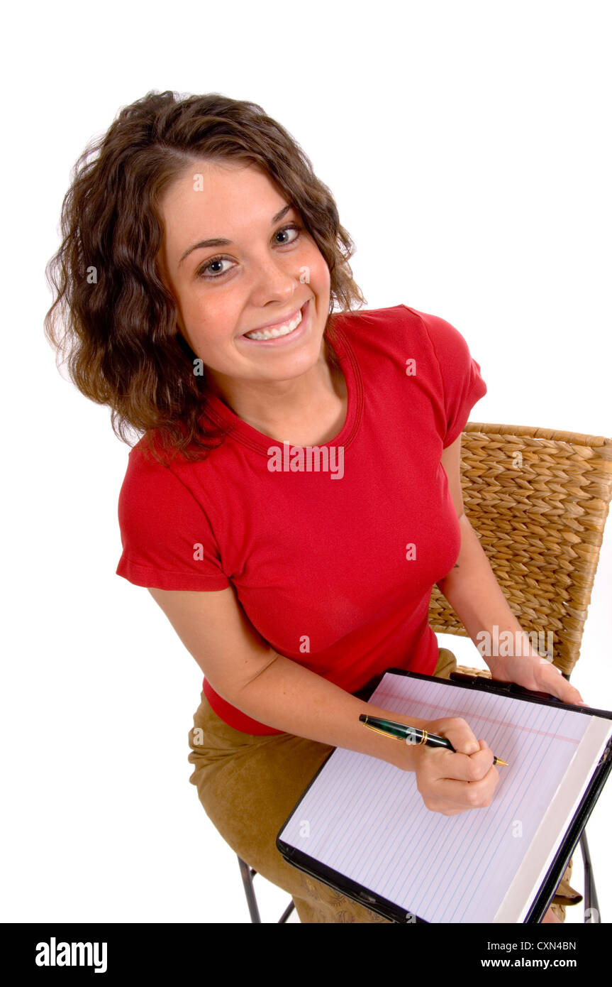 Pretty young business woman with tablet ready to take notes or ...