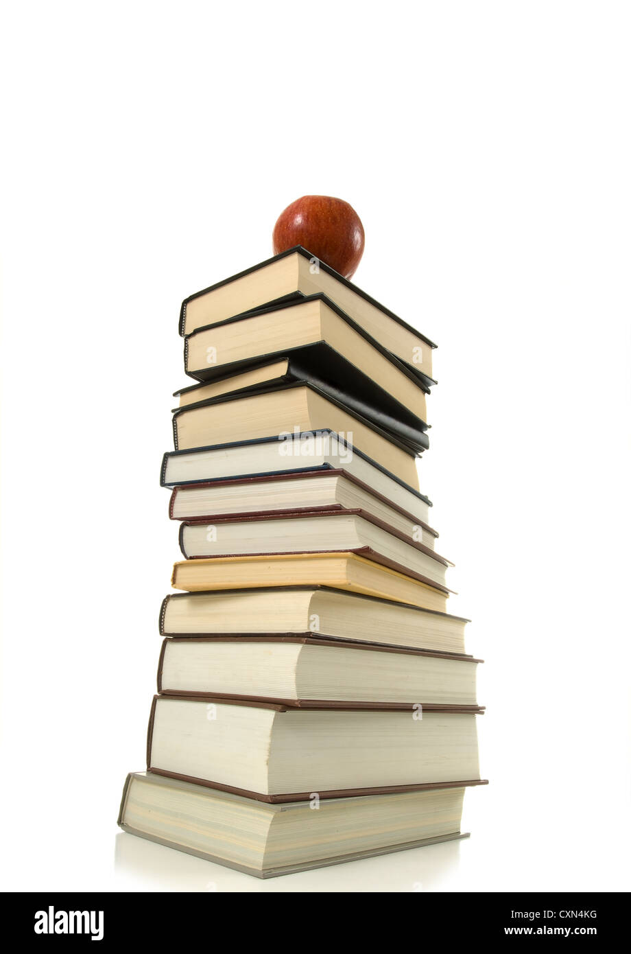 Huge stack of books with a shiny red apple on top on white background ...