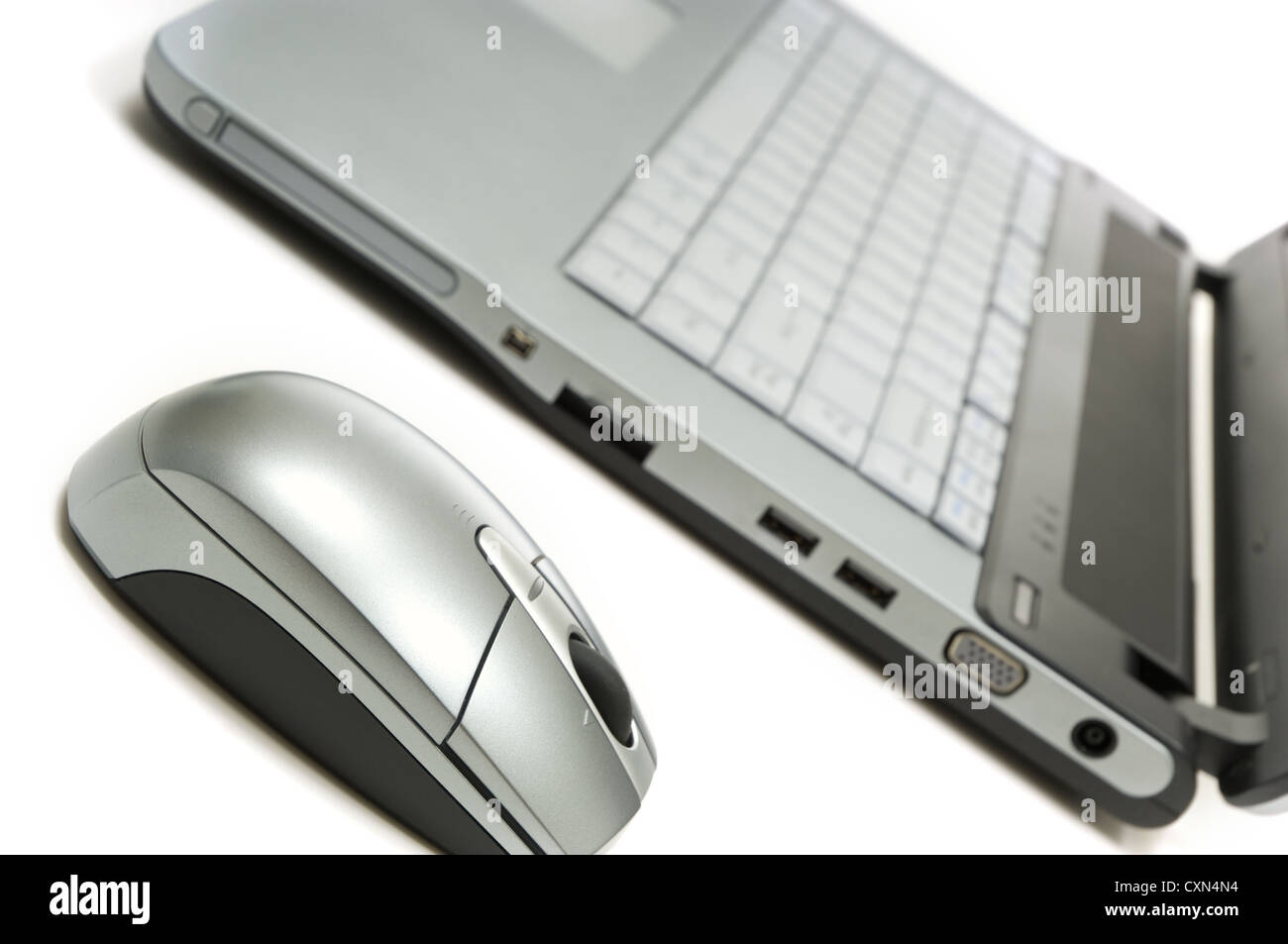 Laptop computer and mouse on white background Stock Photo - Alamy