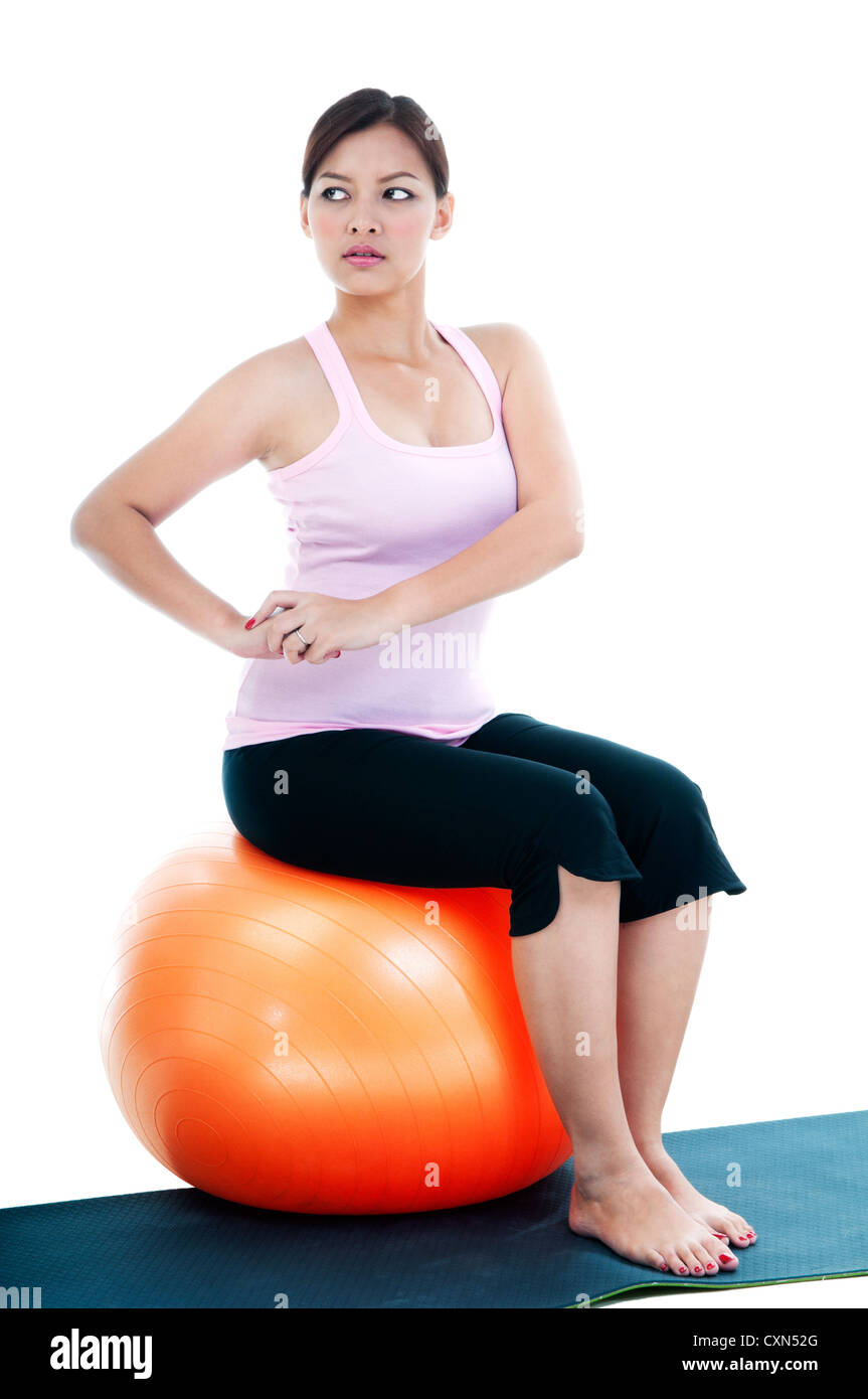 Fitness woman sitting on balance ball Stock Photo - Alamy