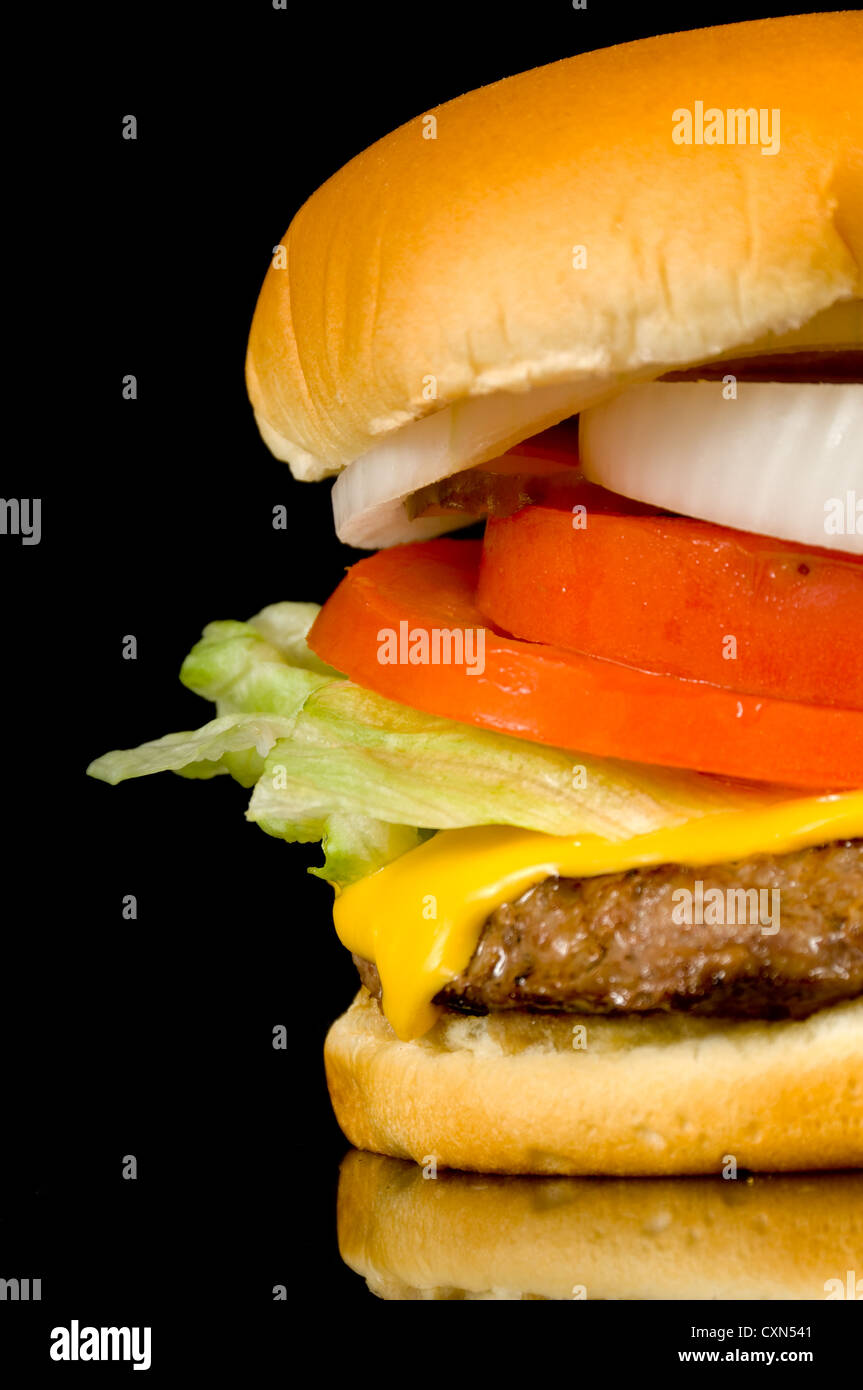 Hearty hamburger closeup on black background - add black to the left ...