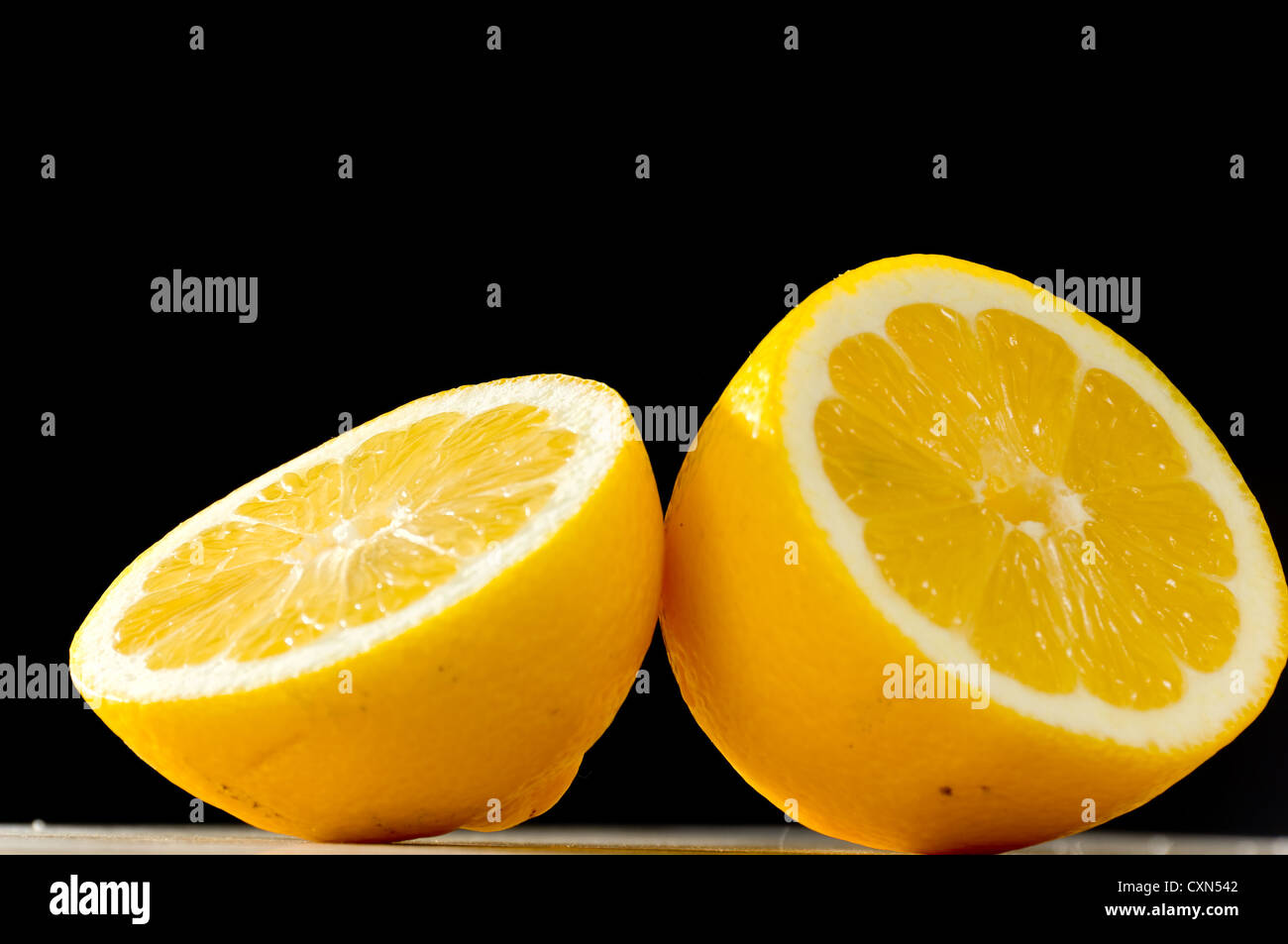 Lemon on black background Stock Photo - Alamy