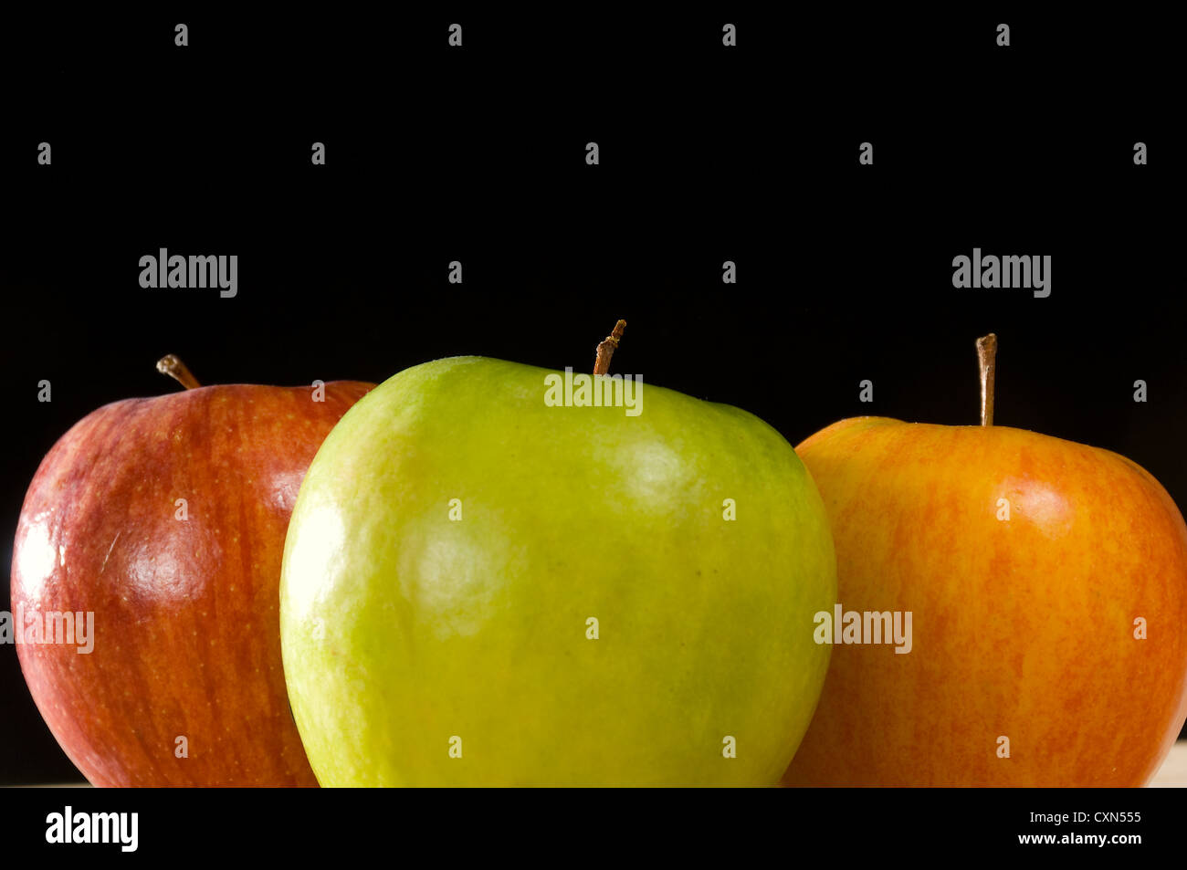 Three varieties of apples on black background Stock Photo - Alamy