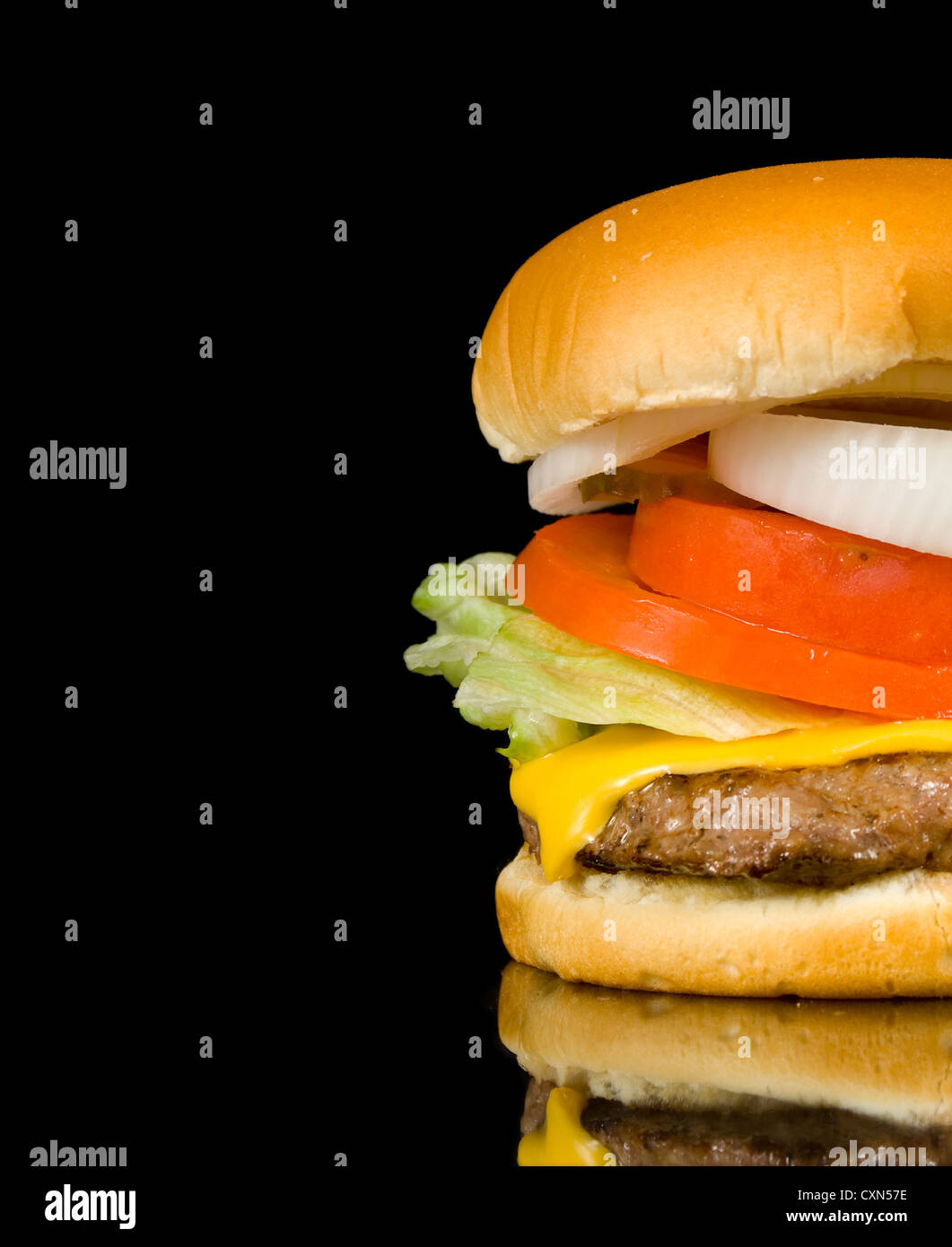 Hearty hamburger closeup on black background Stock Photo - Alamy