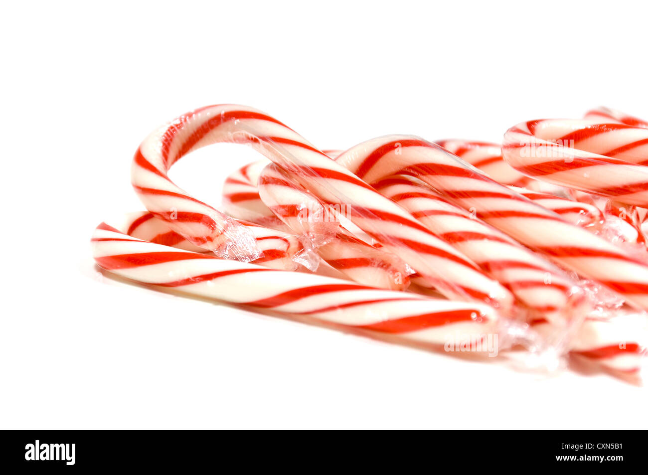 Stack of red and white candy canes on white background- Christmas candy ...