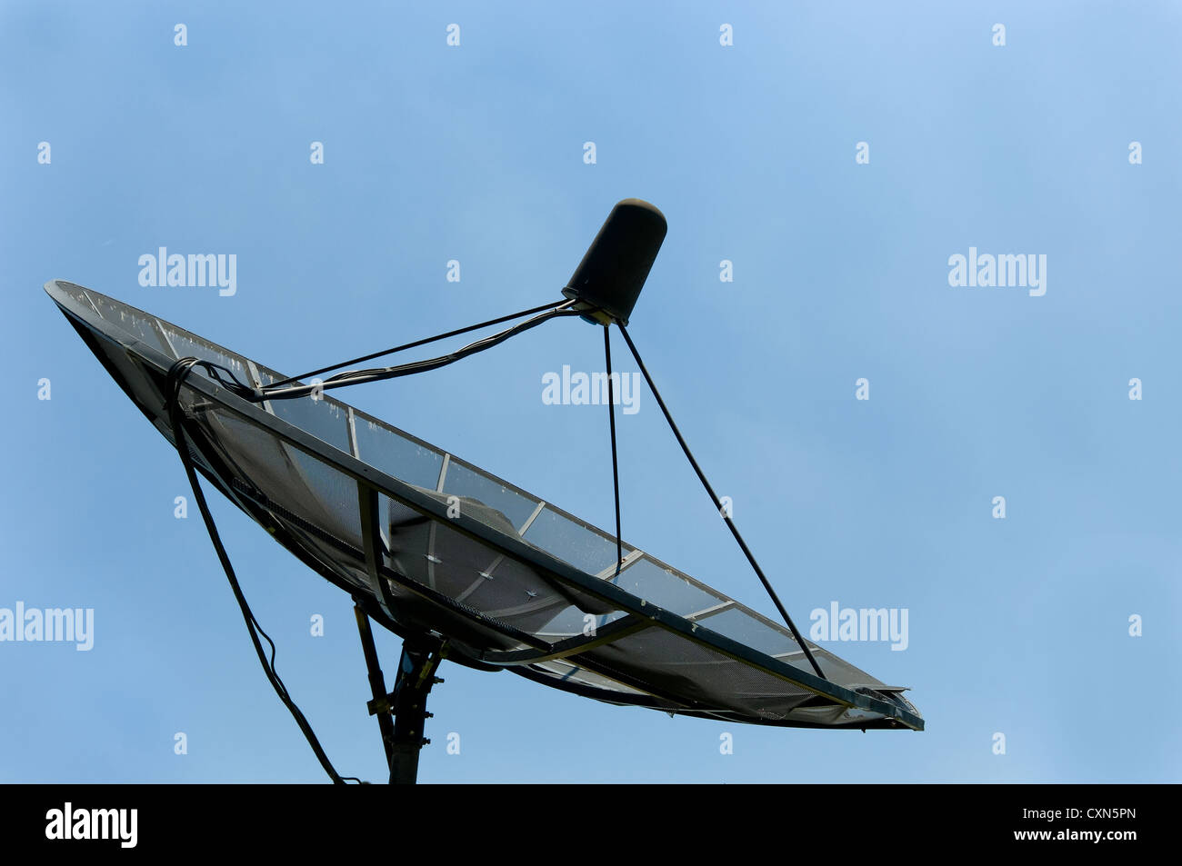 Old satellite dish on blue sky with room for copy Stock Photo - Alamy