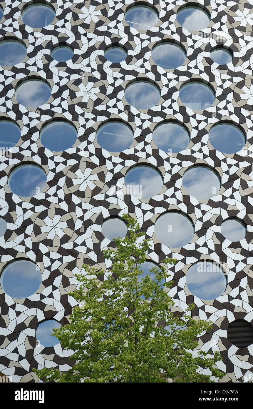Modern architectural cladding with interlocking metallic shapes forms ...