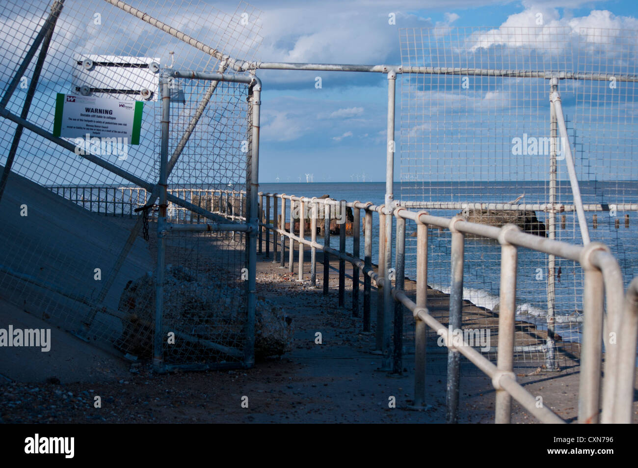 Fence and warning signs on sea wall path Corton Cliffs Stock Photo - Alamy