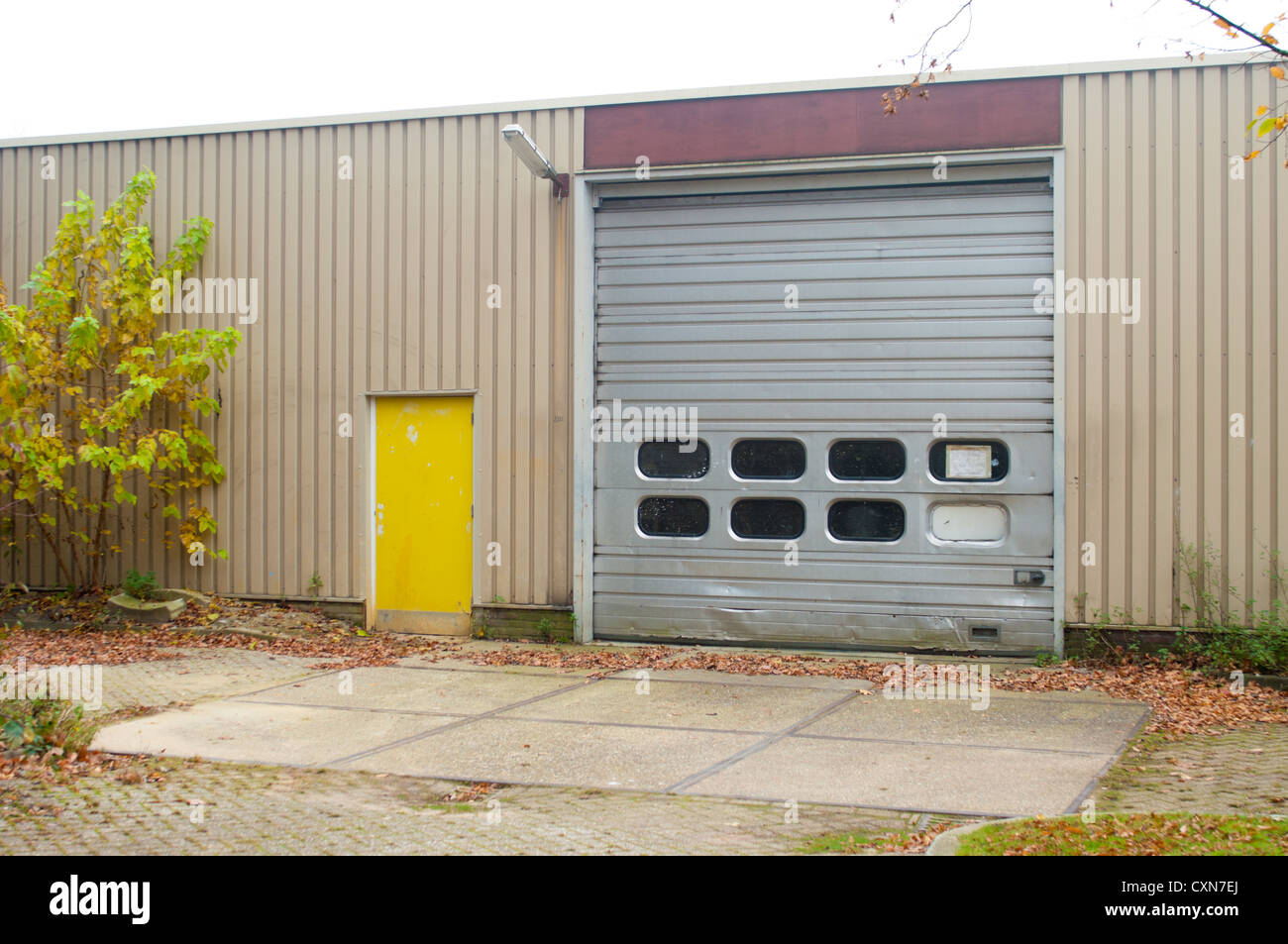 industrial warehouse with damaged roller door Stock Photo - Alamy