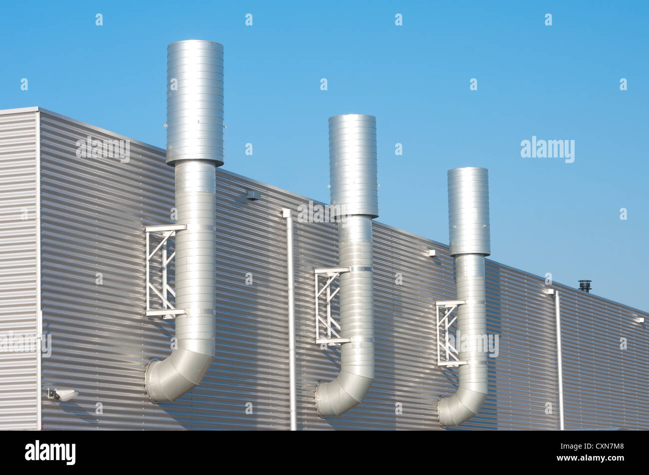 three chimneys on an industrial building Stock Photo - Alamy