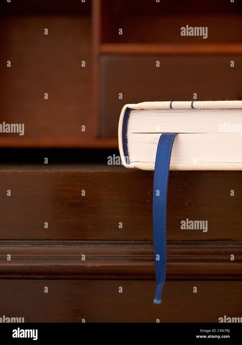 Closed book with blue bookmark Stock Photo - Alamy