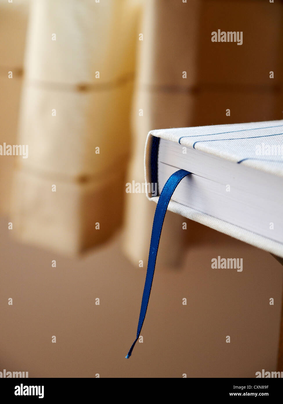 Closed book with blue bookmark Stock Photo - Alamy