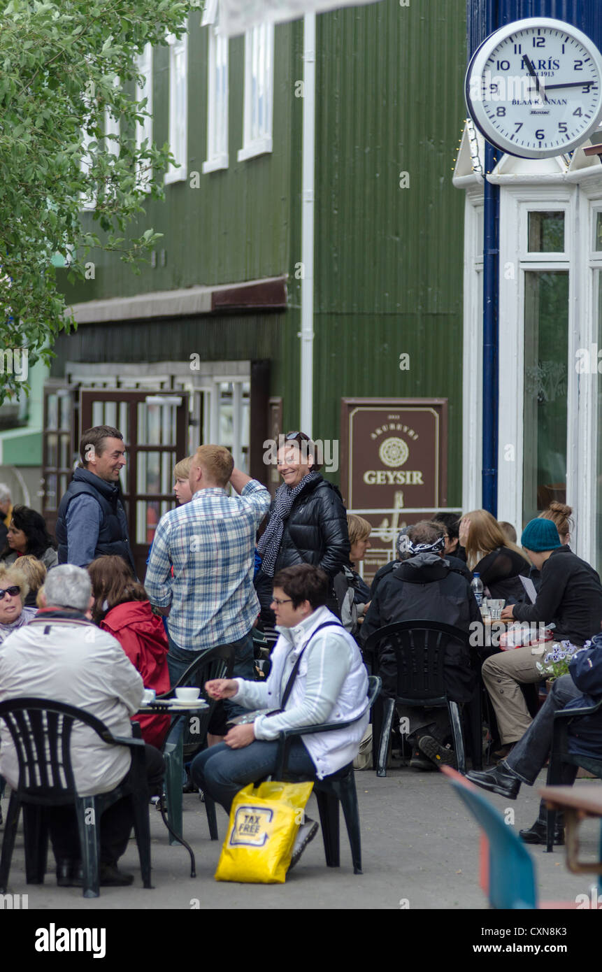People seating in Street and terrace of Akureyri city, Iceland Stock ...