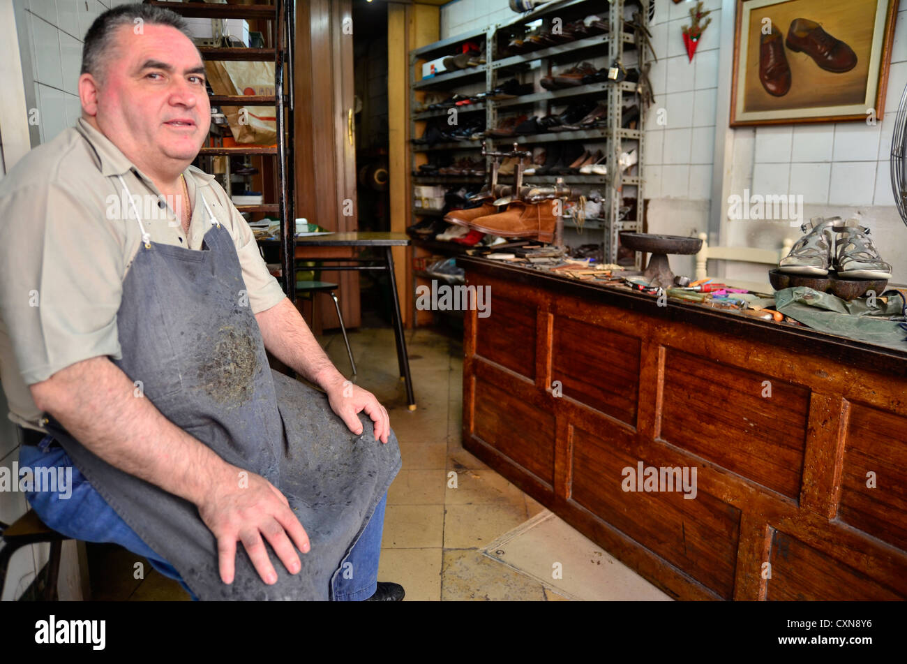 Cobbler in his workshop Stock Photo - Alamy
