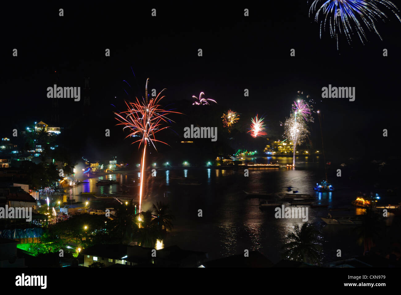 Happy New Year fireworks firework display over the tropical Asian ...