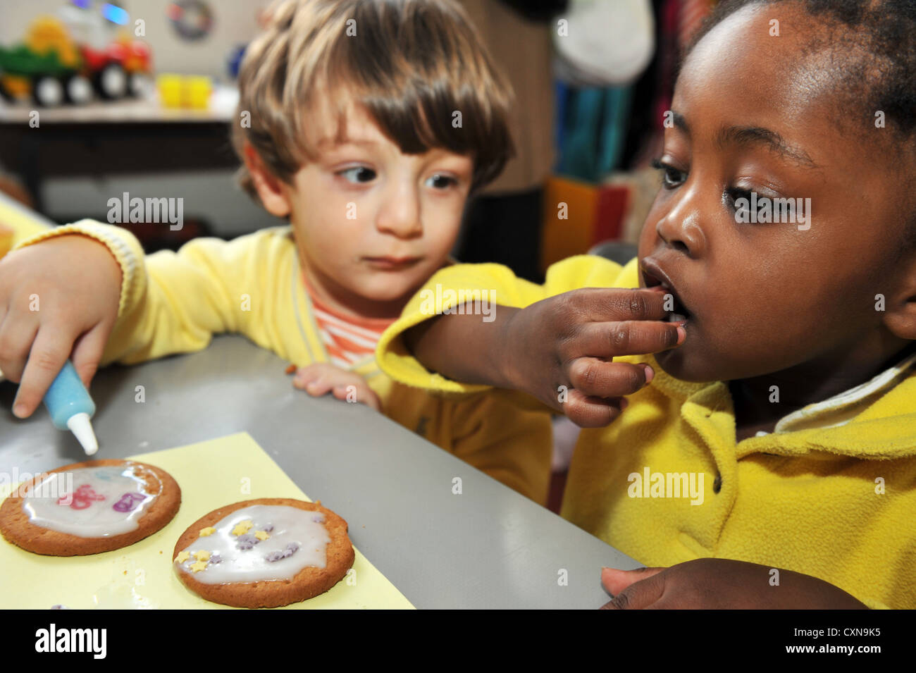 Children make iced biscuits for Comic Relief Stock Photo - Alamy
