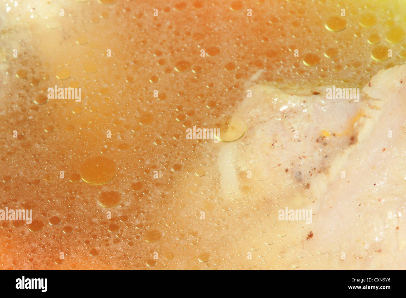 Oil drop floating on soup Stock Photo - Alamy
