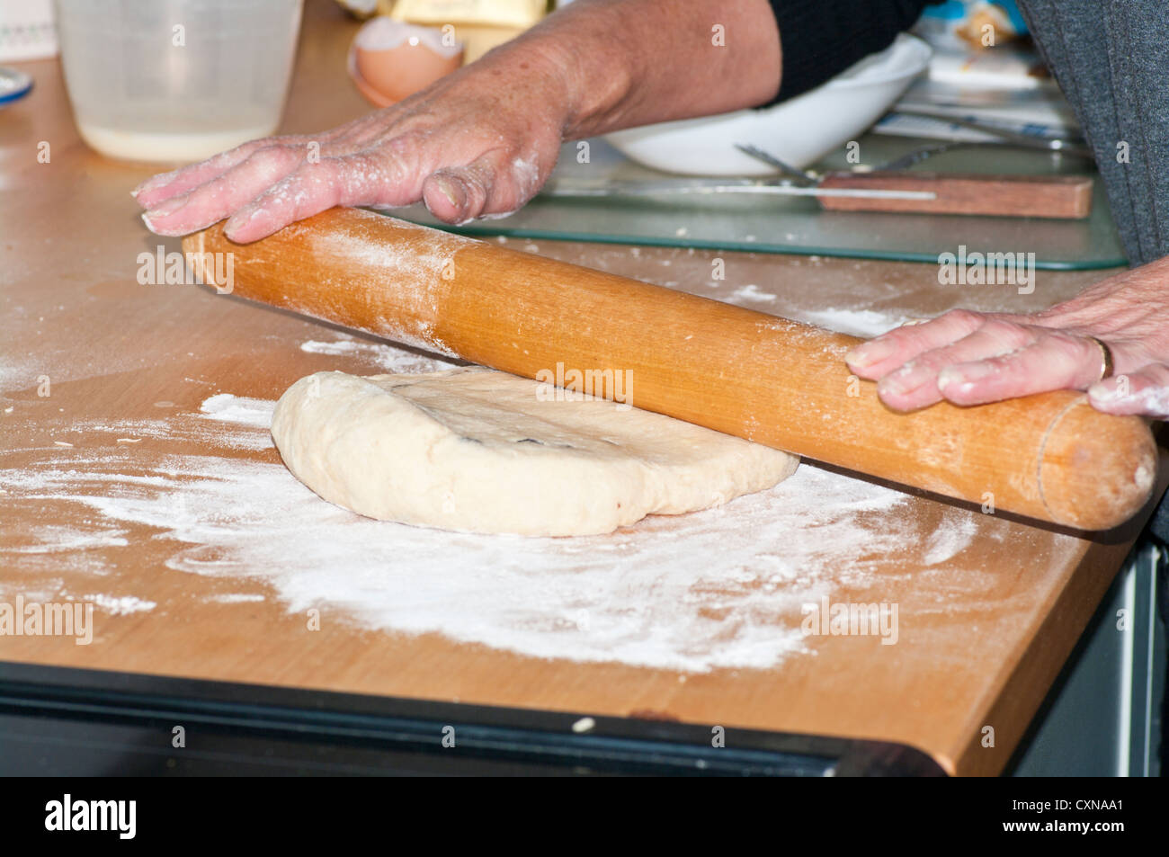Hands using wooden rolling pin hi-res stock photography and images - Alamy