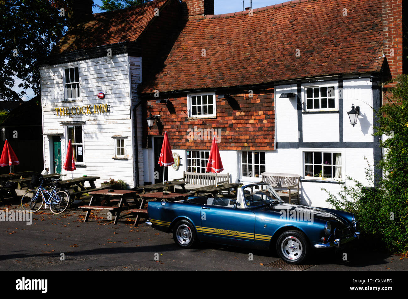 A 1967 Sunbeam Alpine parked outside The Cock Inn in Ide Hill, Kent ...