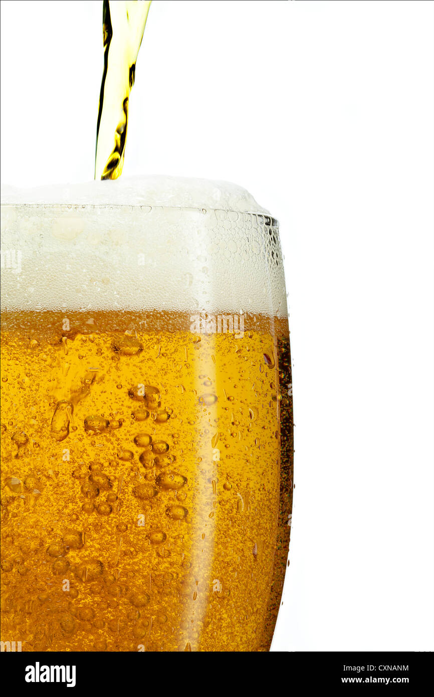 Lager Being poured into pint glass on white Background Stock Photo - Alamy