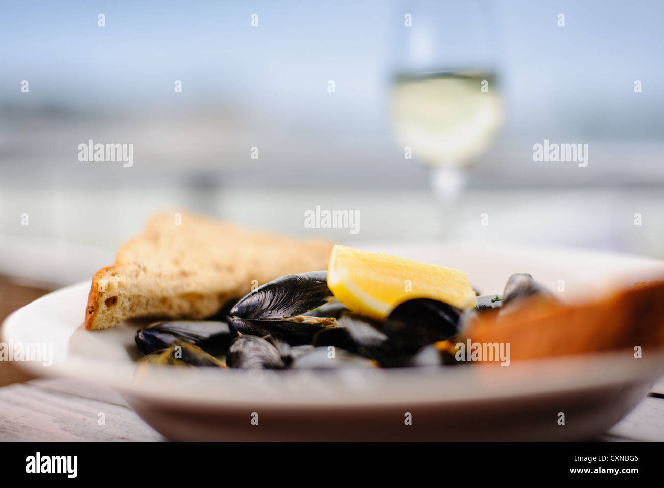 A bowl of fresh Cornish mussels, served with fresh granary bread and a ...